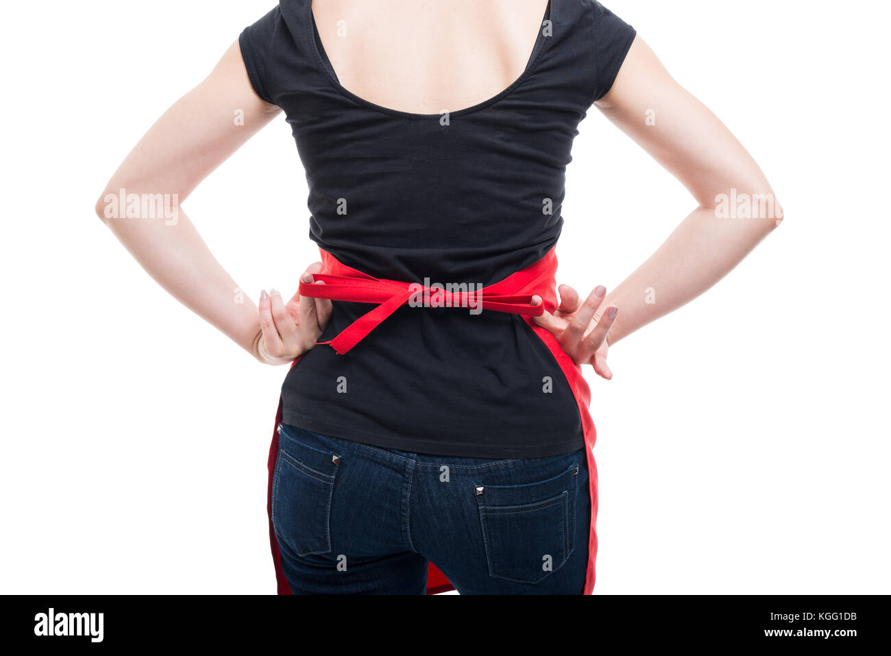 Girl employee in rear view adjusting her apron and making a knot Stock ...