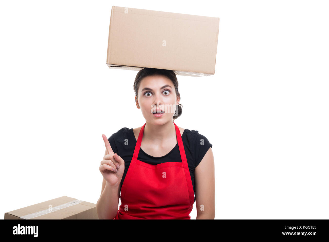 Young woman employee carrying cardboard box on her head and having a ...