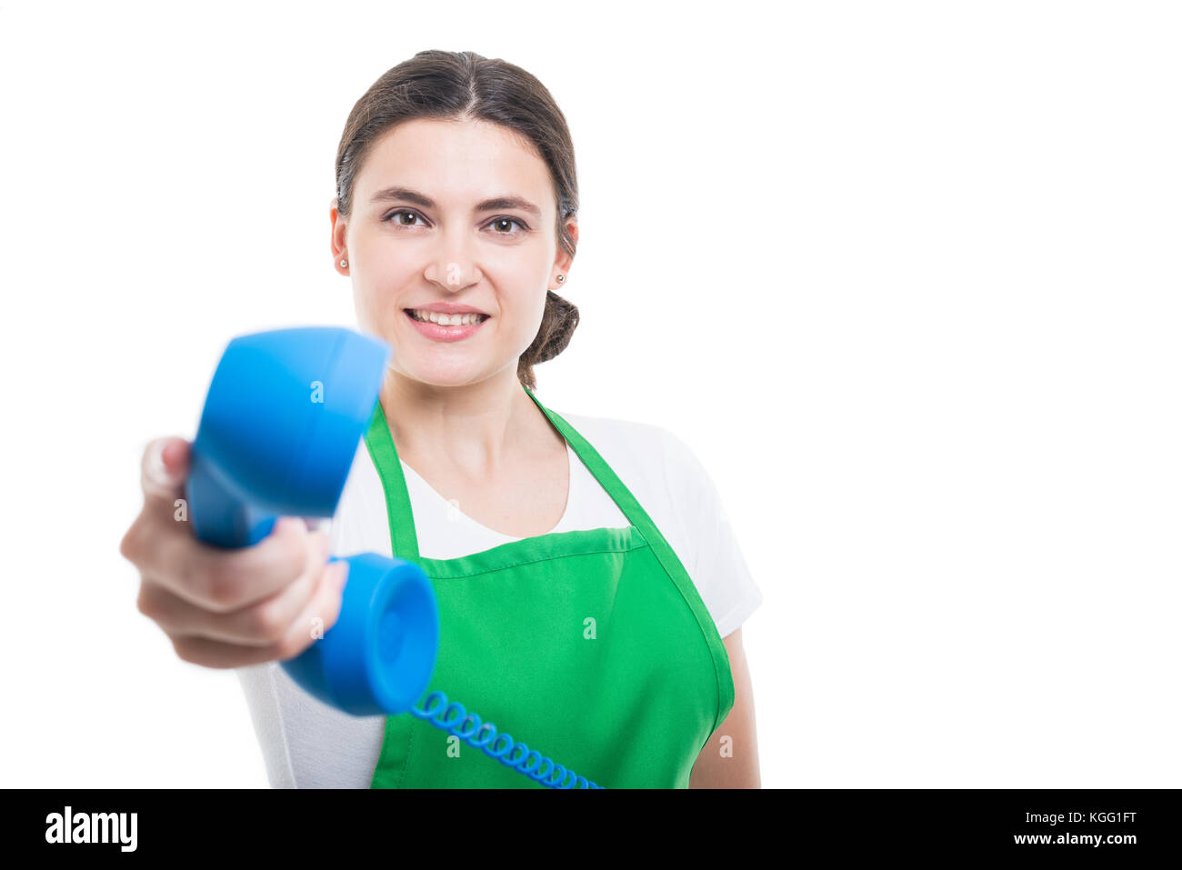Young female employee holding phone receiver after talking with a ...