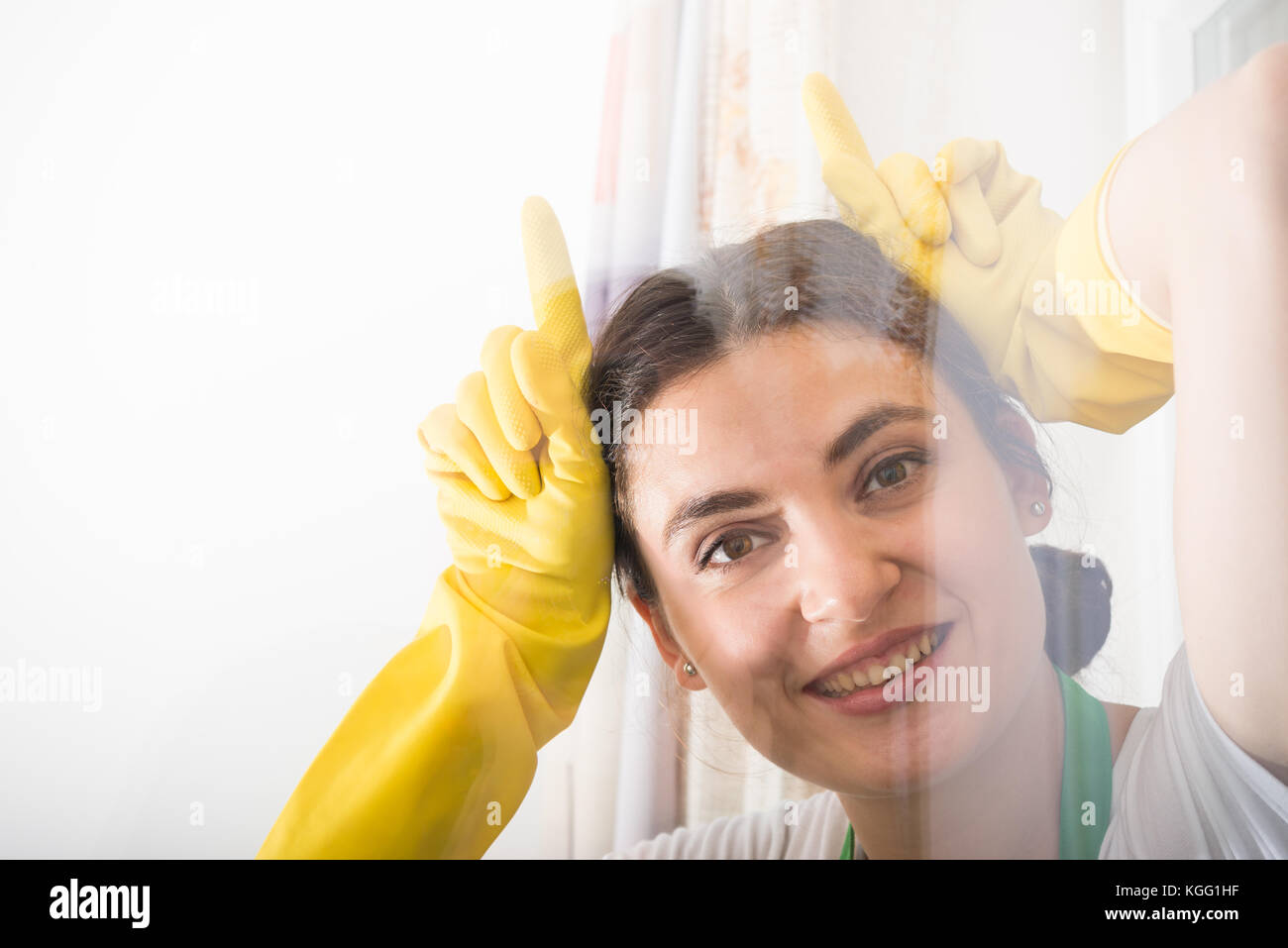 Cheerful cleaning woman acting funny and washing the house window Stock ...