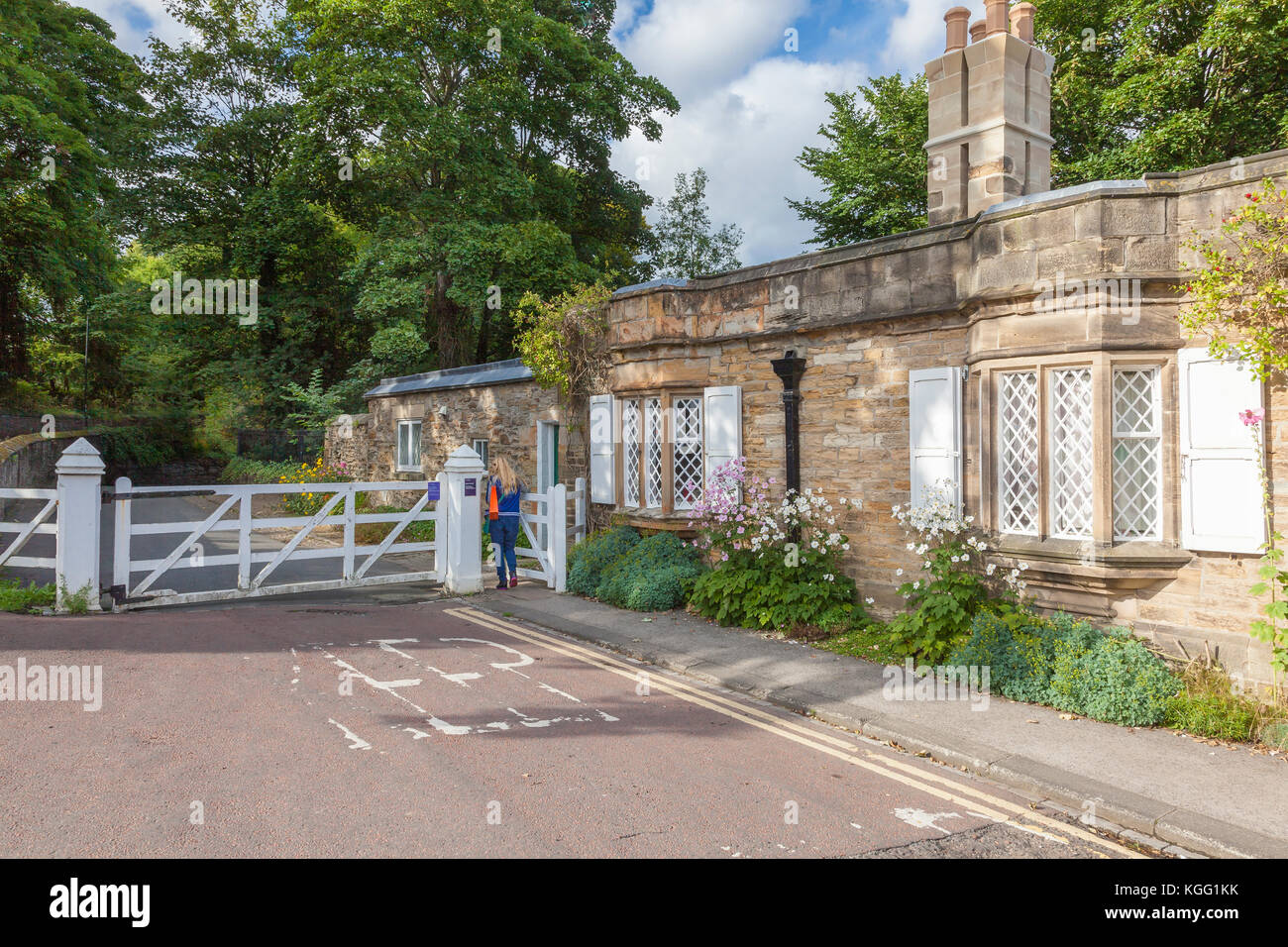 A woman makes her way past the old Toll Cottage and Gate on Quarryheads ...