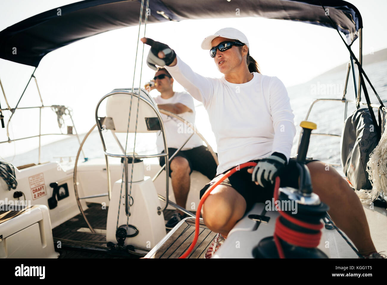 Attractive strong woman sailing with her boat Stock Photo - Alamy