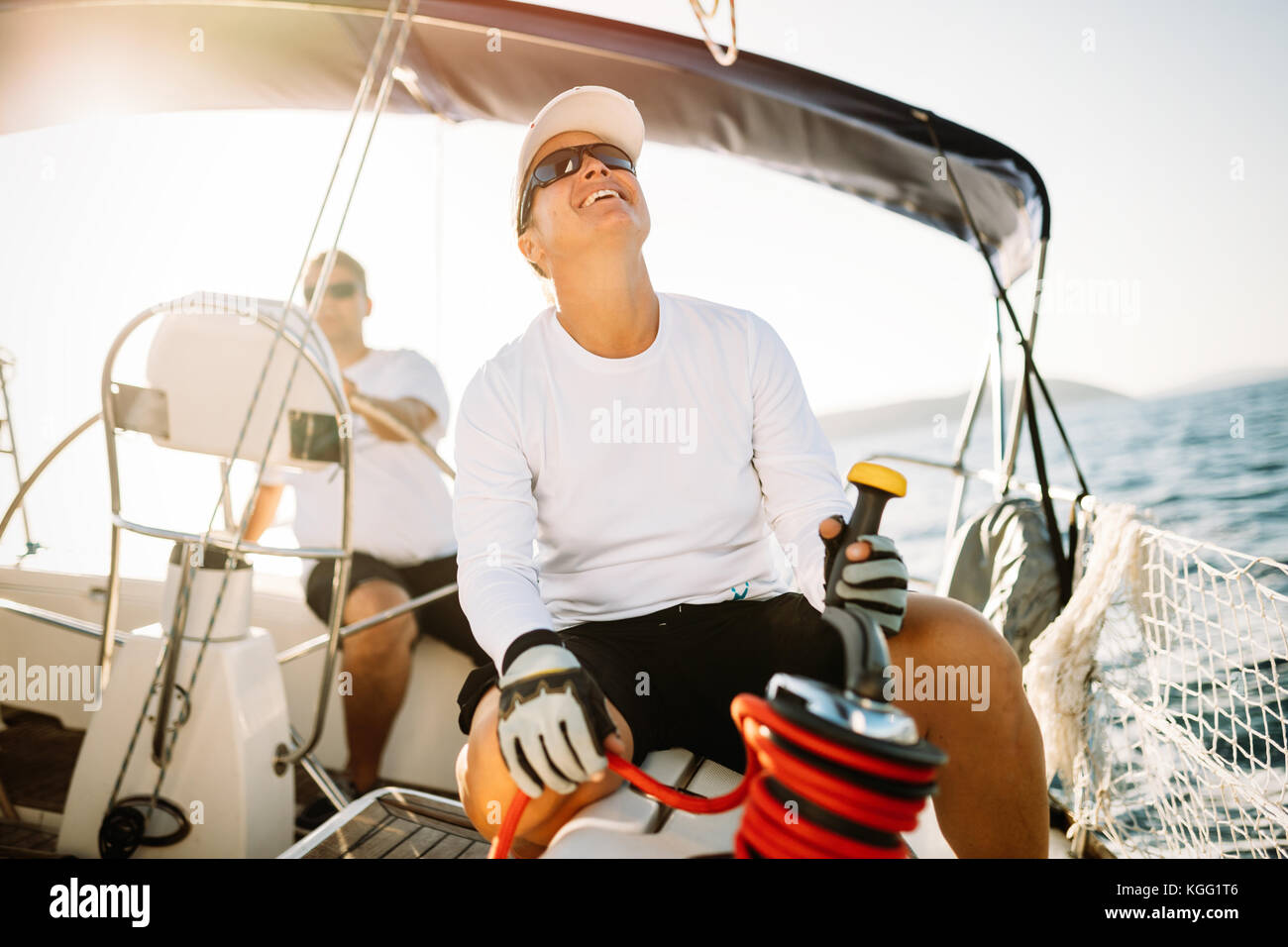 Attractive strong woman sailing with her boat Stock Photo - Alamy