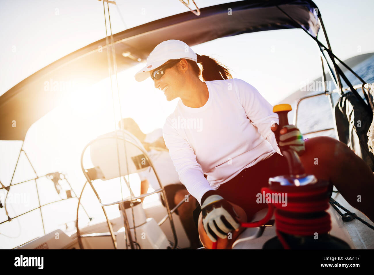 Attractive strong woman sailing with her boat Stock Photo - Alamy