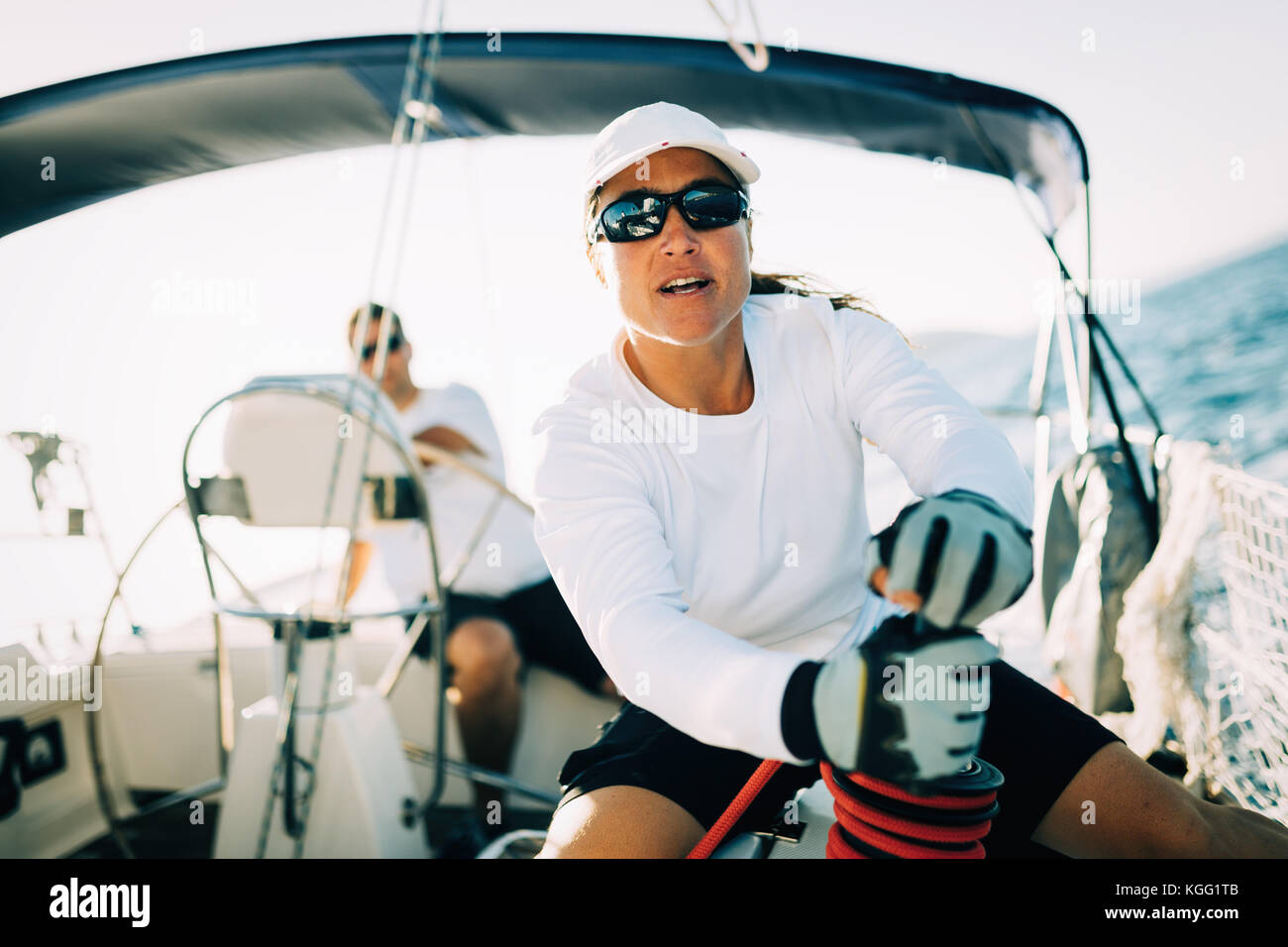 Attractive strong woman sailing with her boat Stock Photo - Alamy