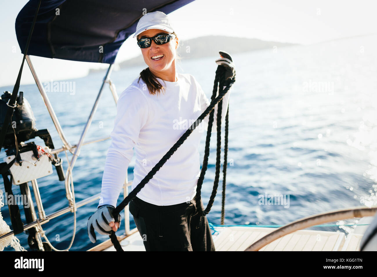 Attractive strong woman sailing with her boat Stock Photo - Alamy