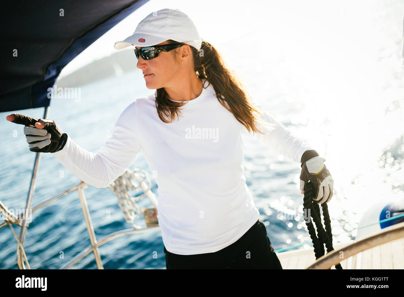 Attractive strong woman sailing with her boat Stock Photo - Alamy