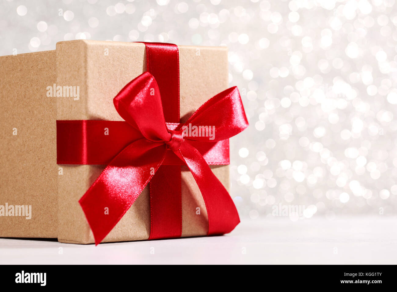 Present box with red bow Stock Photo - Alamy