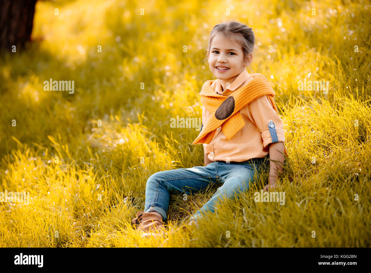 child sitting on grass Stock Photo - Alamy