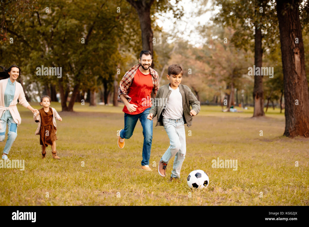 Family playing soccer Stock Photo - Alamy