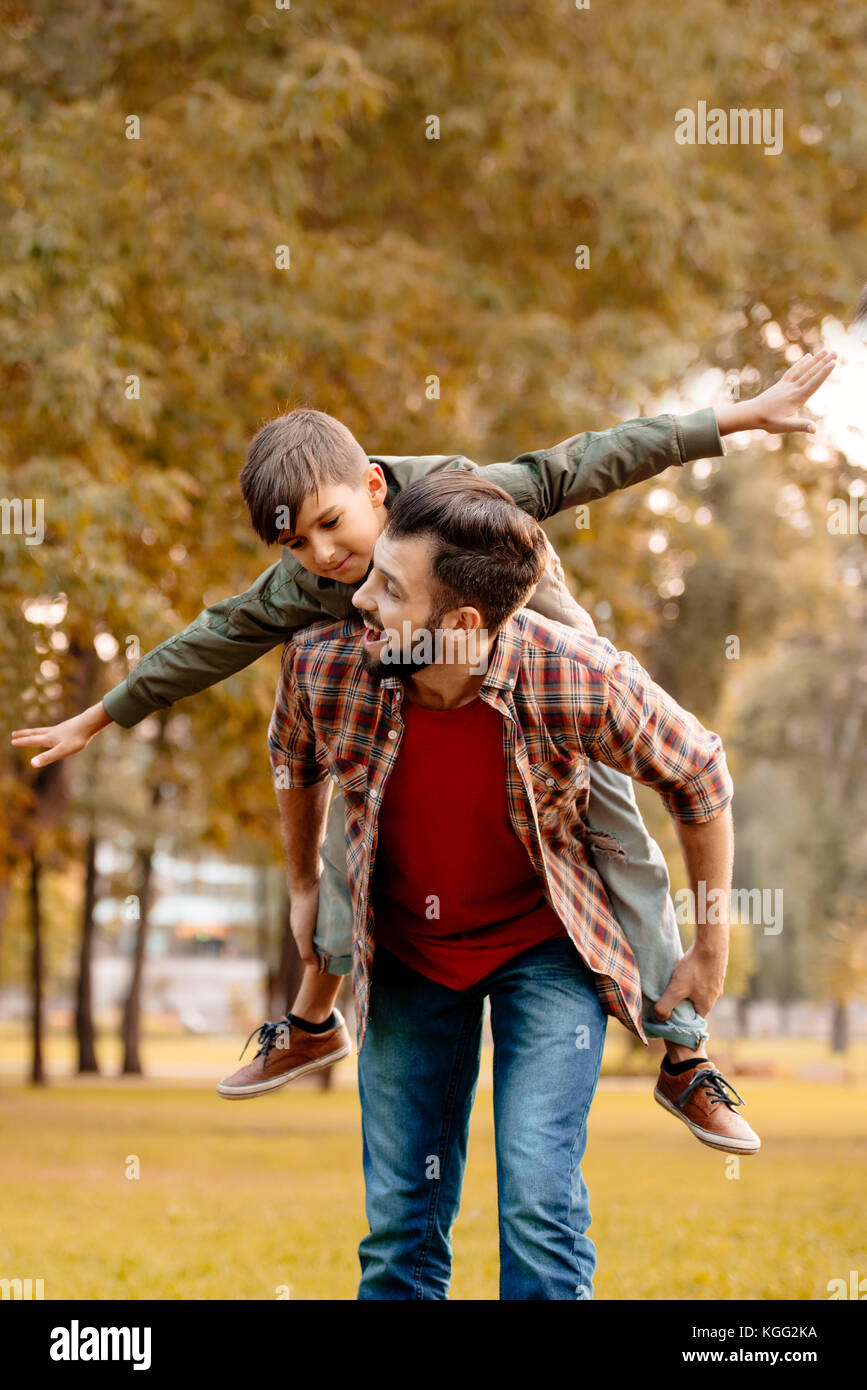 Father giving son piggyback ride Stock Photo - Alamy