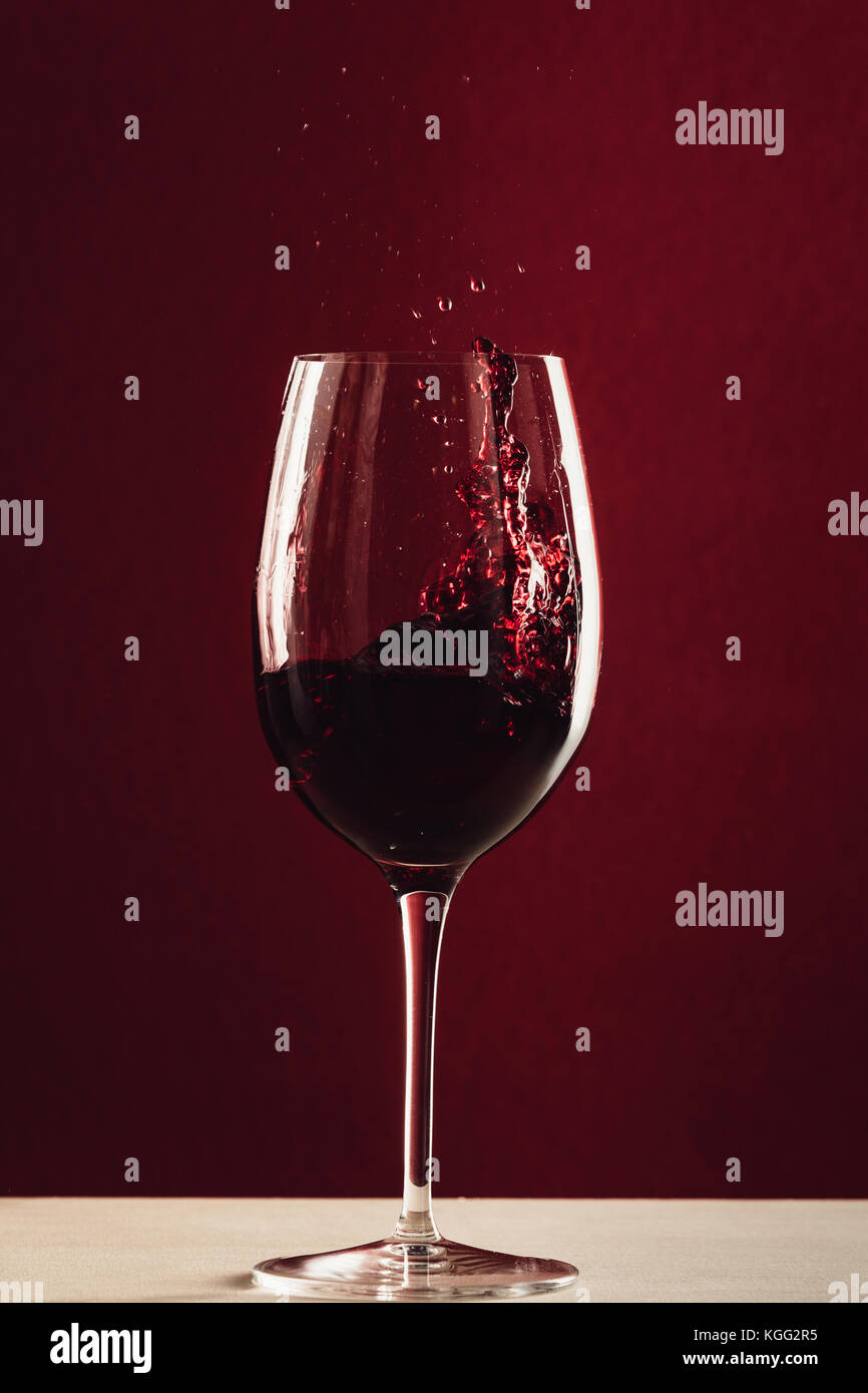 splash of wine in wineglass Stock Photo - Alamy
