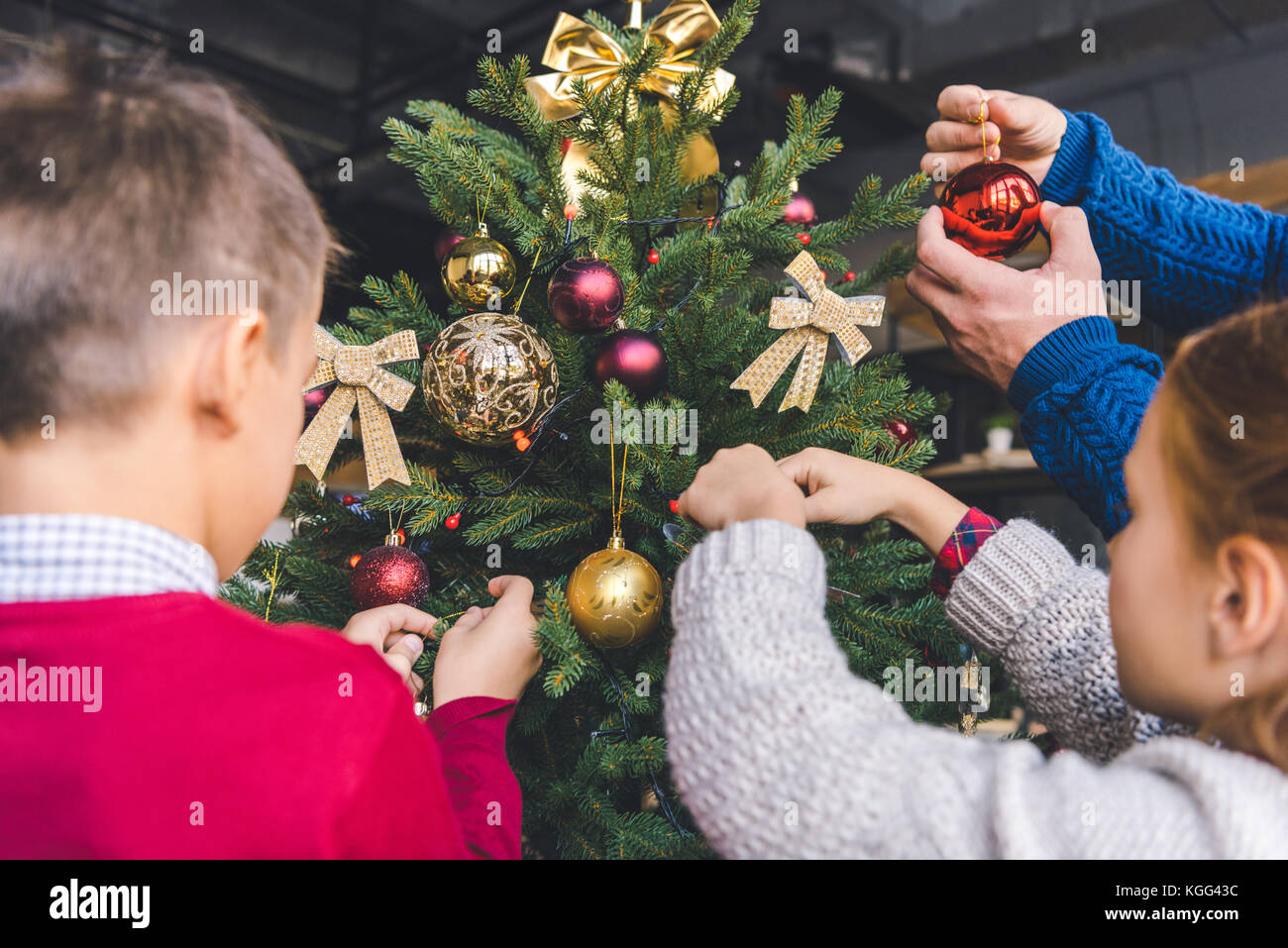 family decorating christmas tree Stock Photo - Alamy
