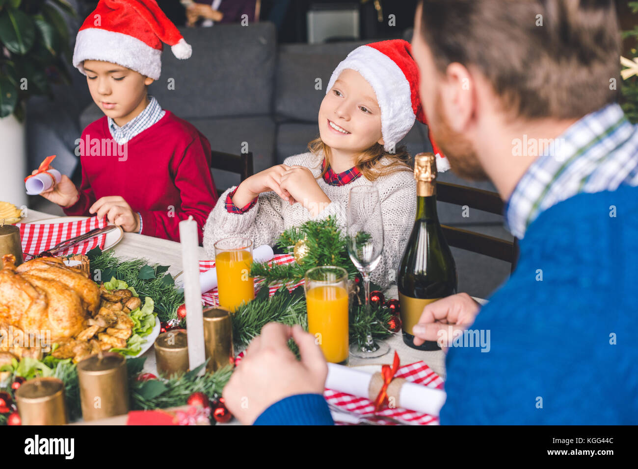 father sitting at christmas table with kids Stock Photo - Alamy