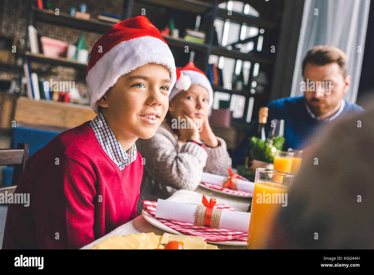 kids sitting at christmas table with father Stock Photo - Alamy
