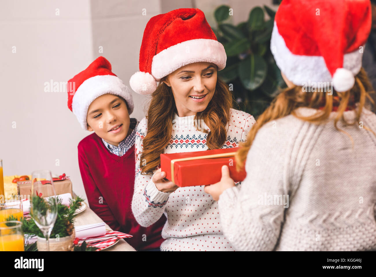 kids giving christmas present to mother Stock Photo - Alamy