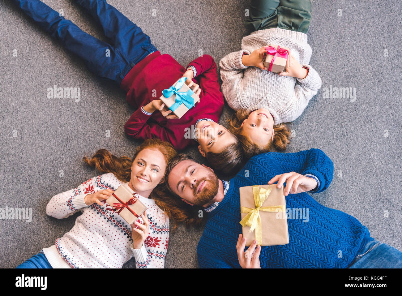 family laying on floor with gifts Stock Photo - Alamy