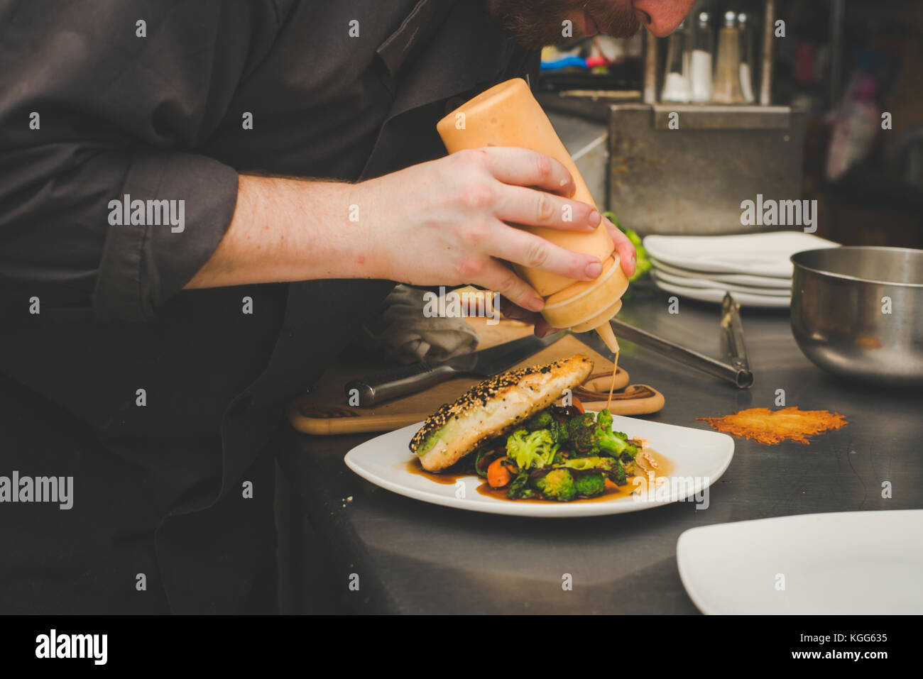 A chef prepares food in the kitchen of a restaurant Stock Photo - Alamy