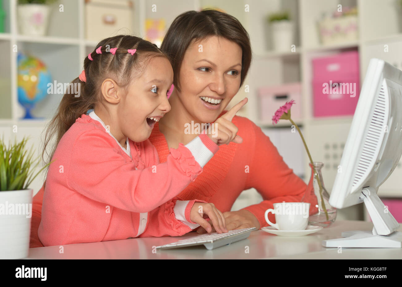 little girl with mother using computer Stock Photo - Alamy