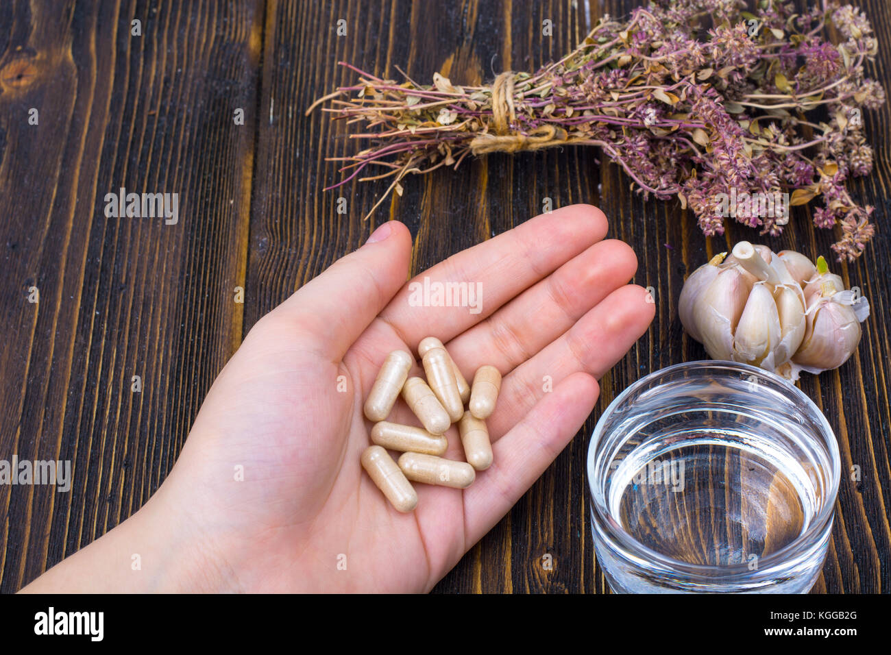 Herbal medicine in capsules from herbs on the palm of your hand for ...