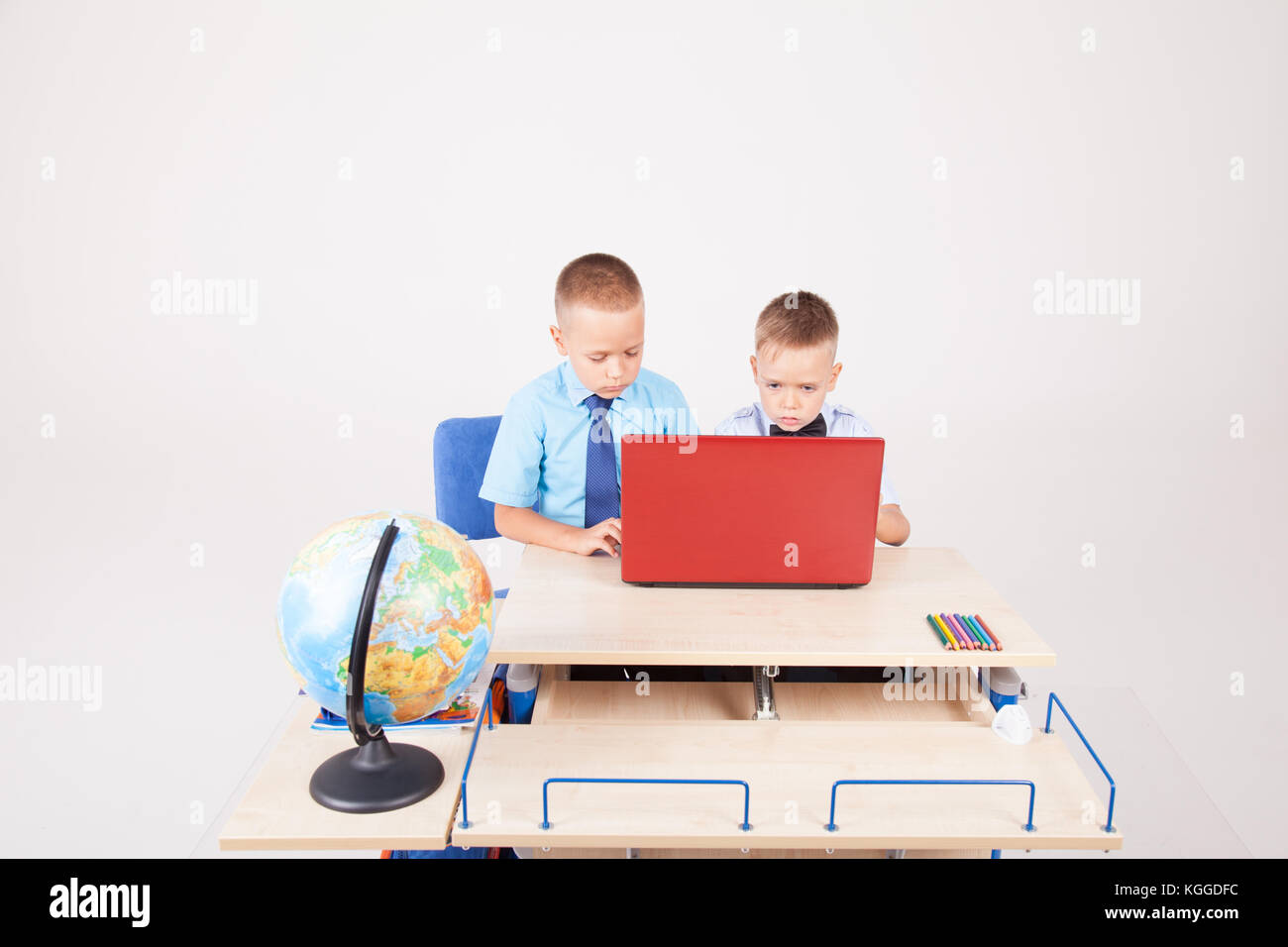 study on the computer two boys at school Stock Photo - Alamy