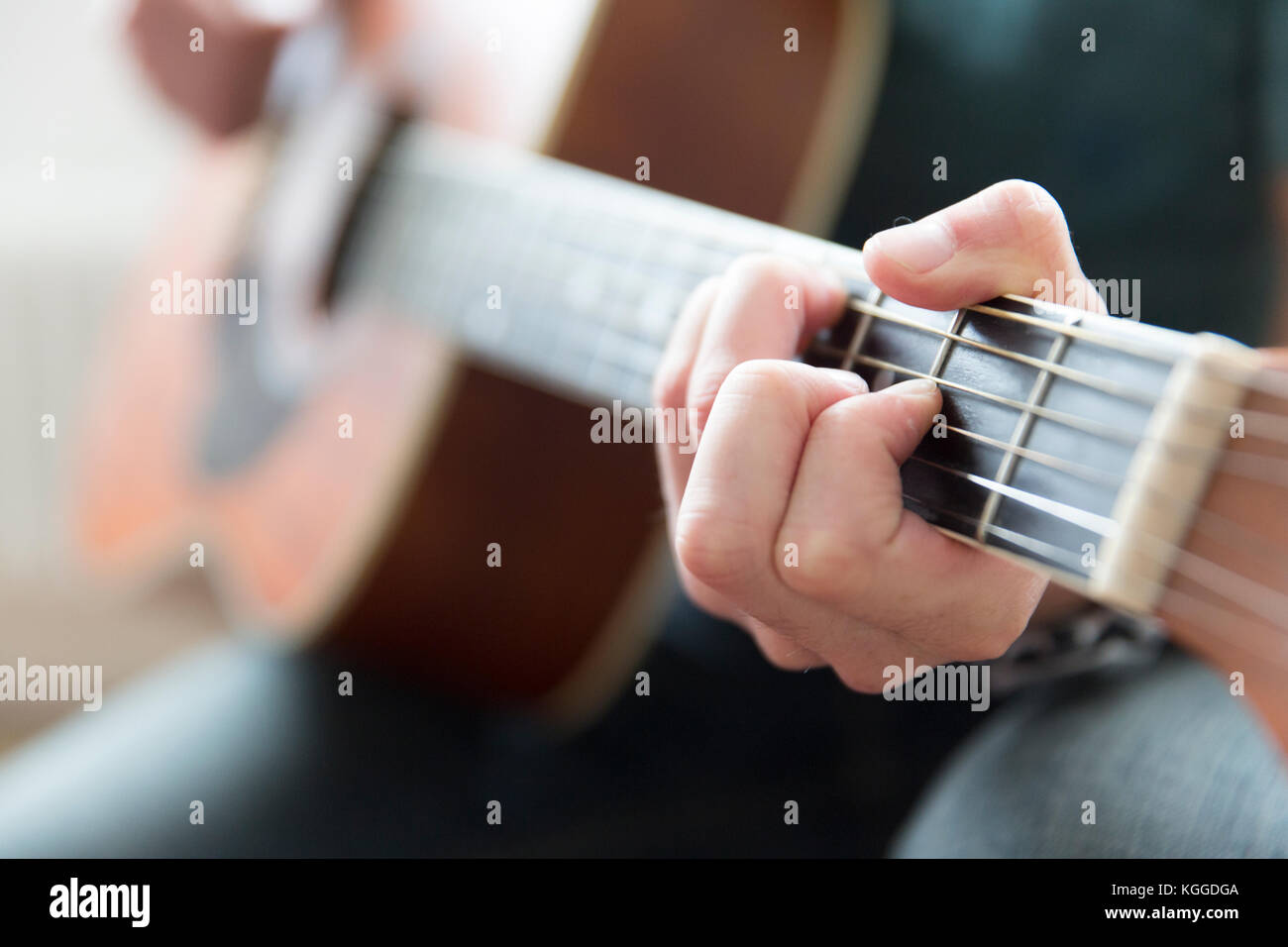 hands playing an acoustic guitar Stock Photo - Alamy