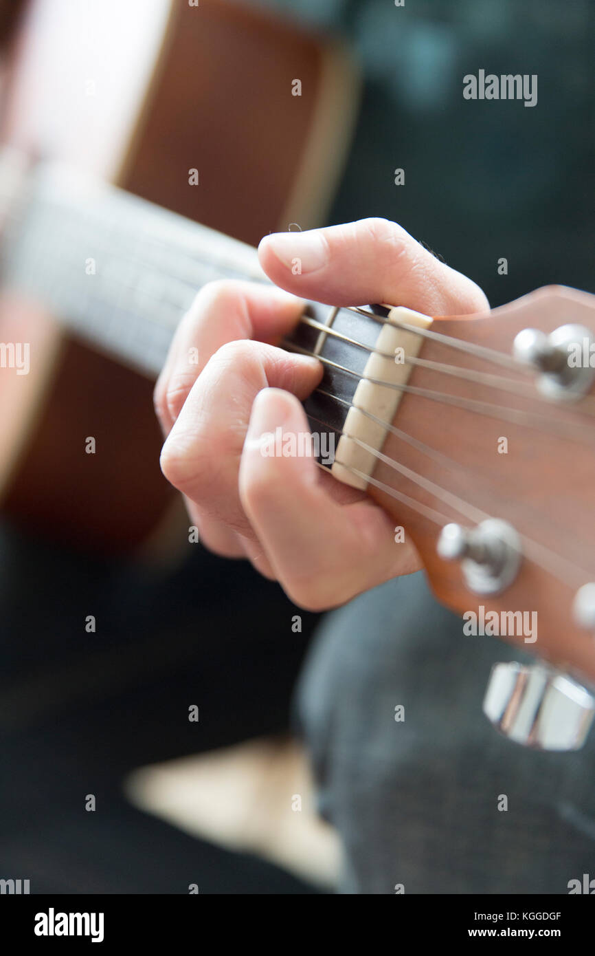 hands playing an acoustic guitar Stock Photo - Alamy