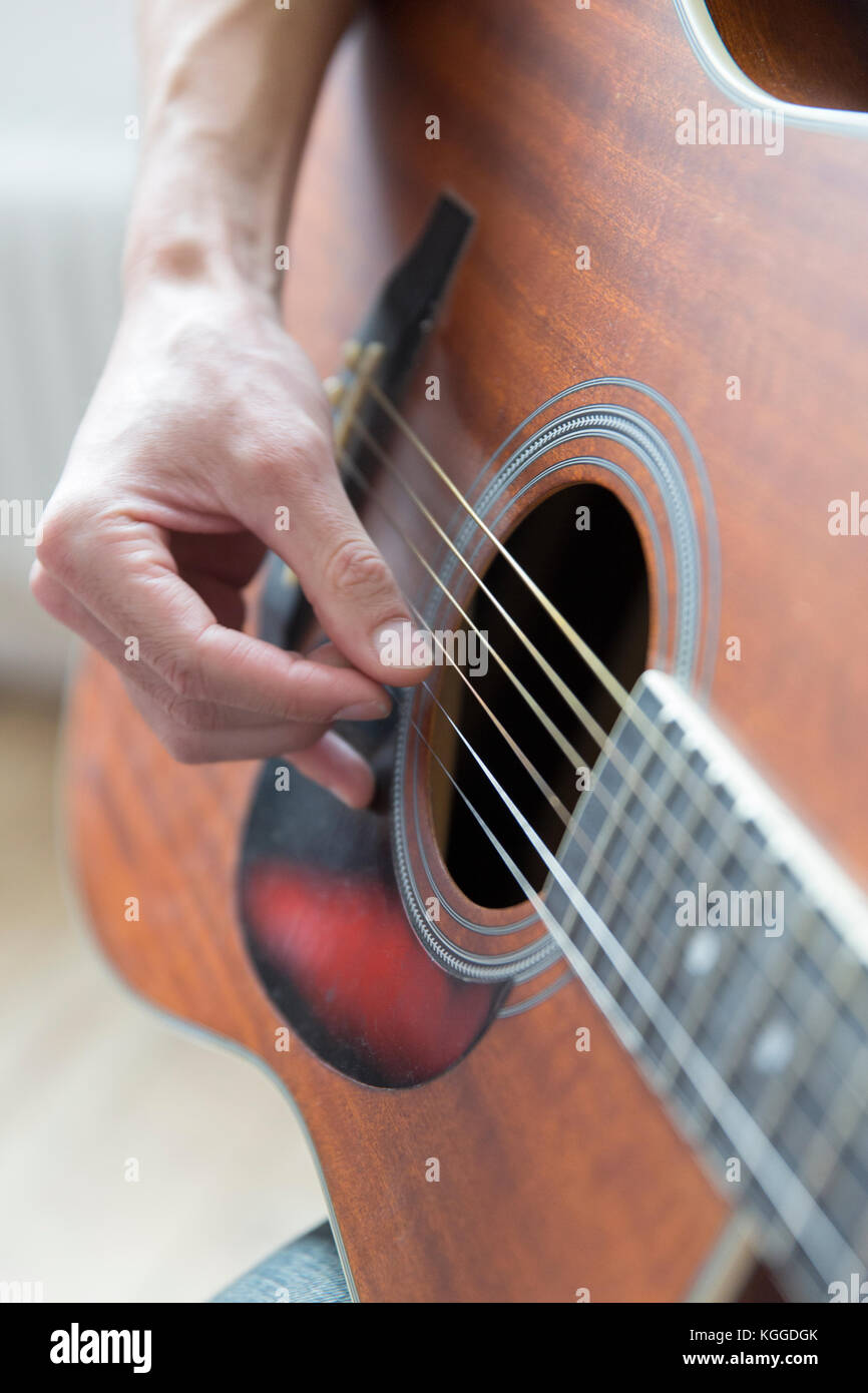 hands playing an acoustic guitar Stock Photo - Alamy
