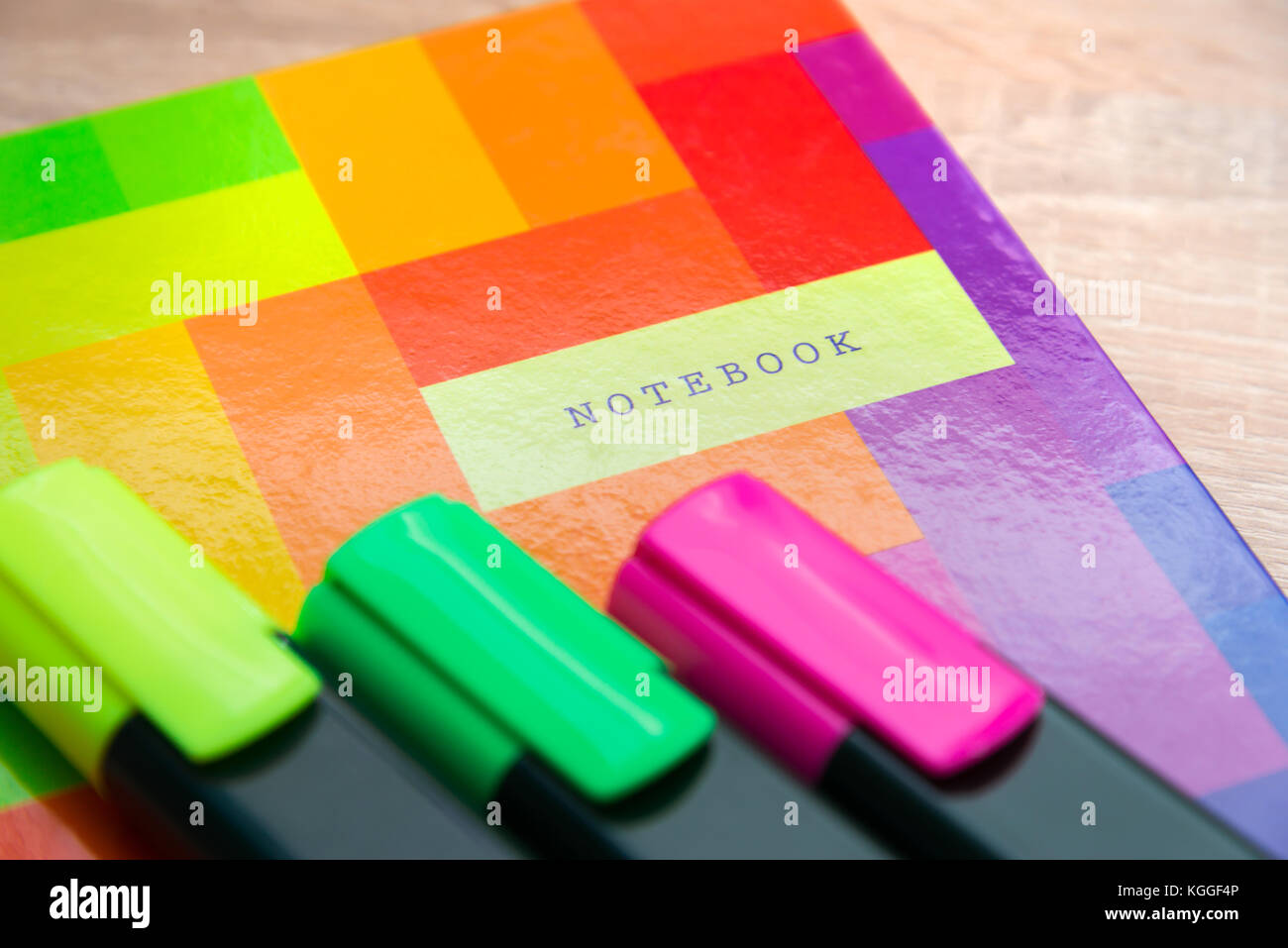 Bright notebook with markers on a wooden background Stock Photo - Alamy
