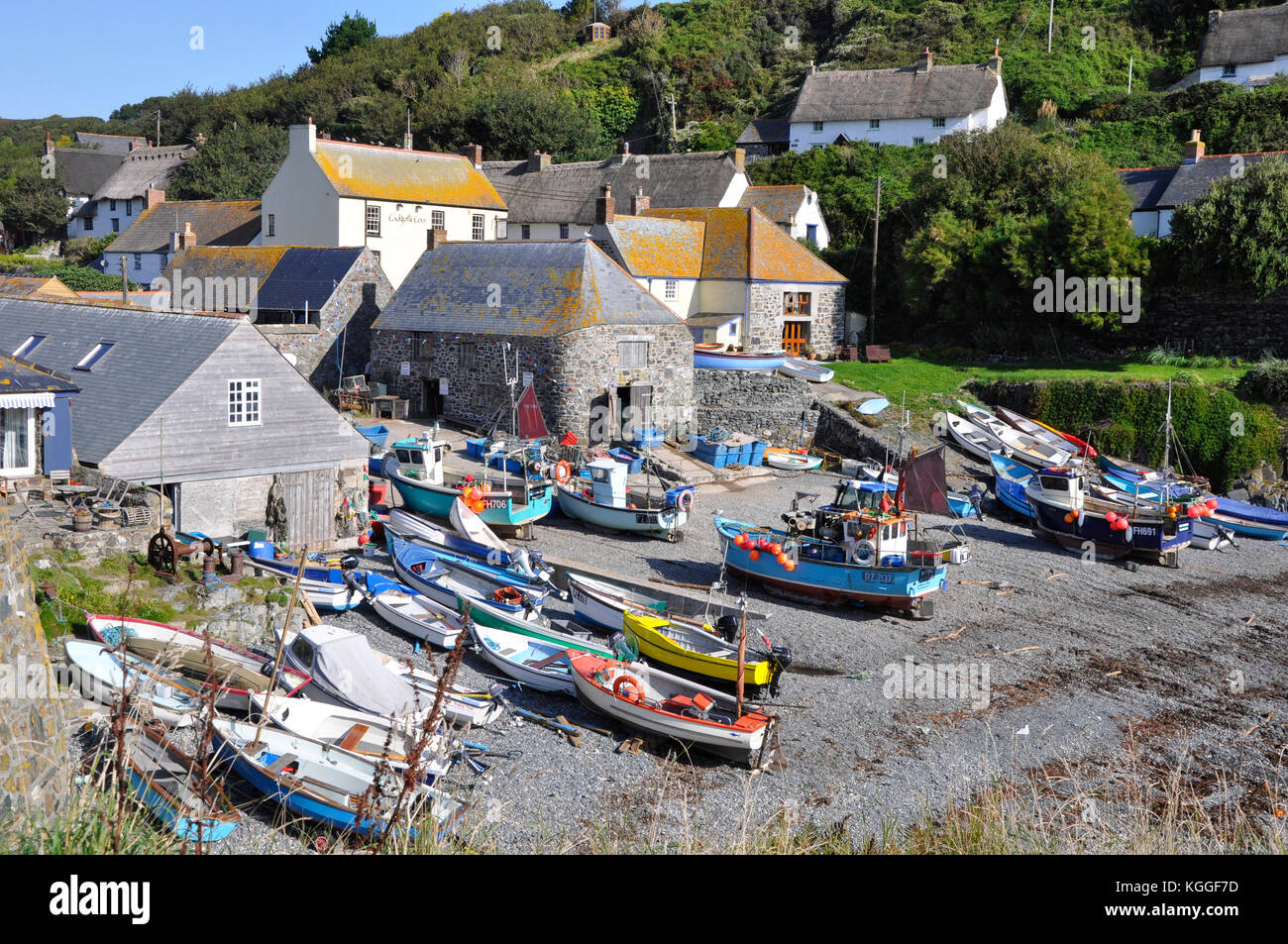 Cadgwith Cove with fishing boats hauled up on the pebble beach.Cornwall ...