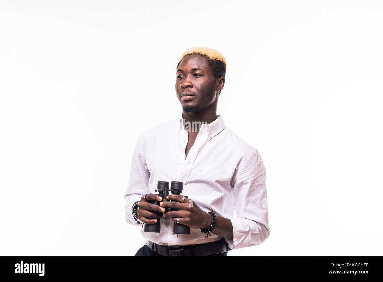 Portrait young handsome focused man looking curious, through fingers ...