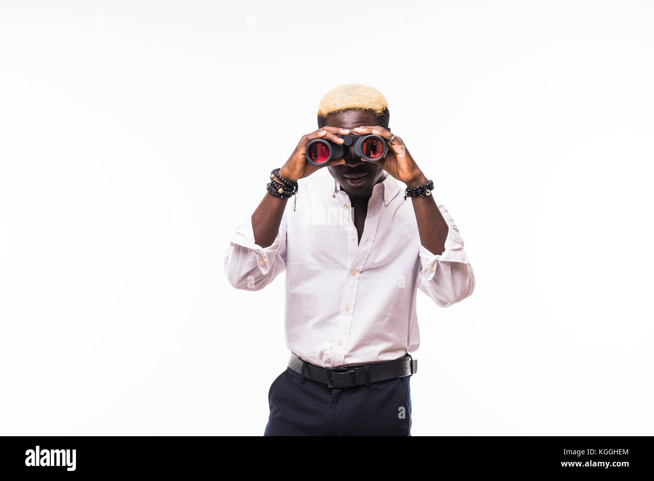 Portrait young handsome focused man looking curious, through fingers ...