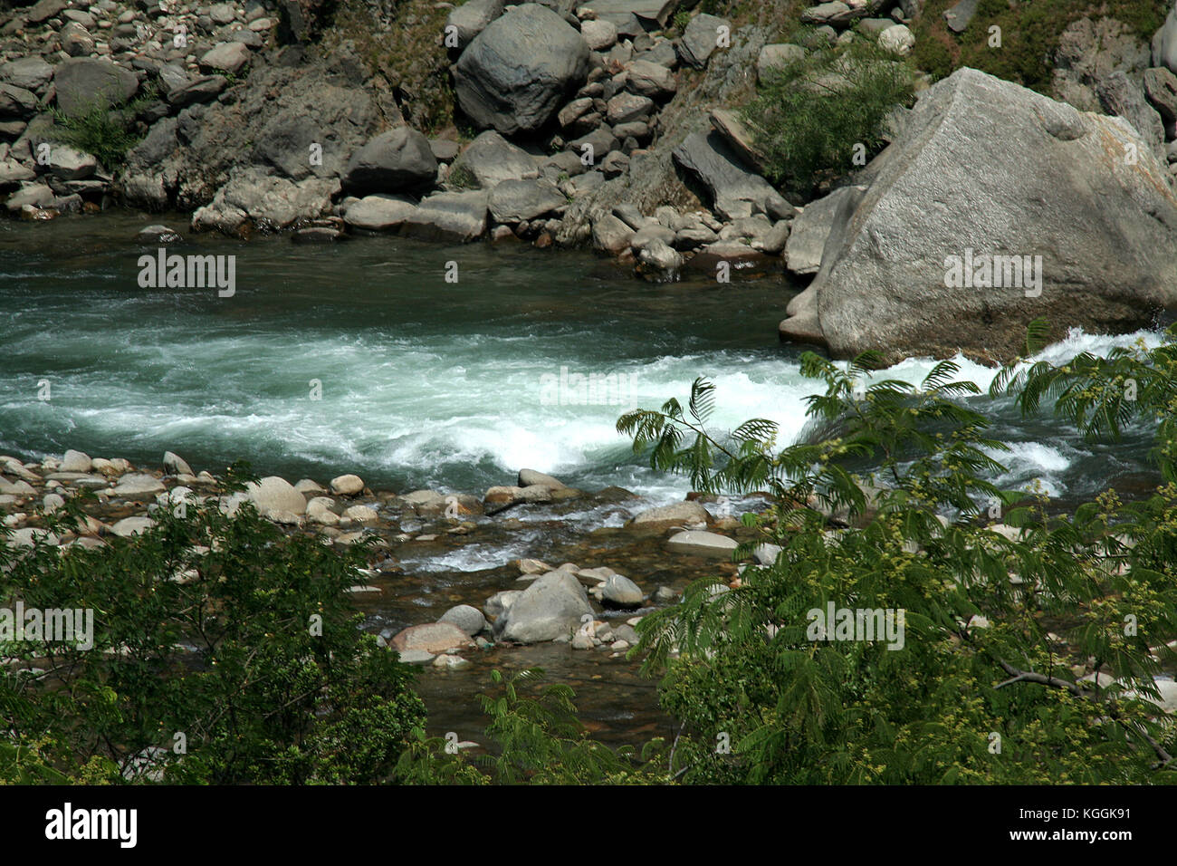 River flowing through boulders, rocks and pebbles Stock Photo - Alamy