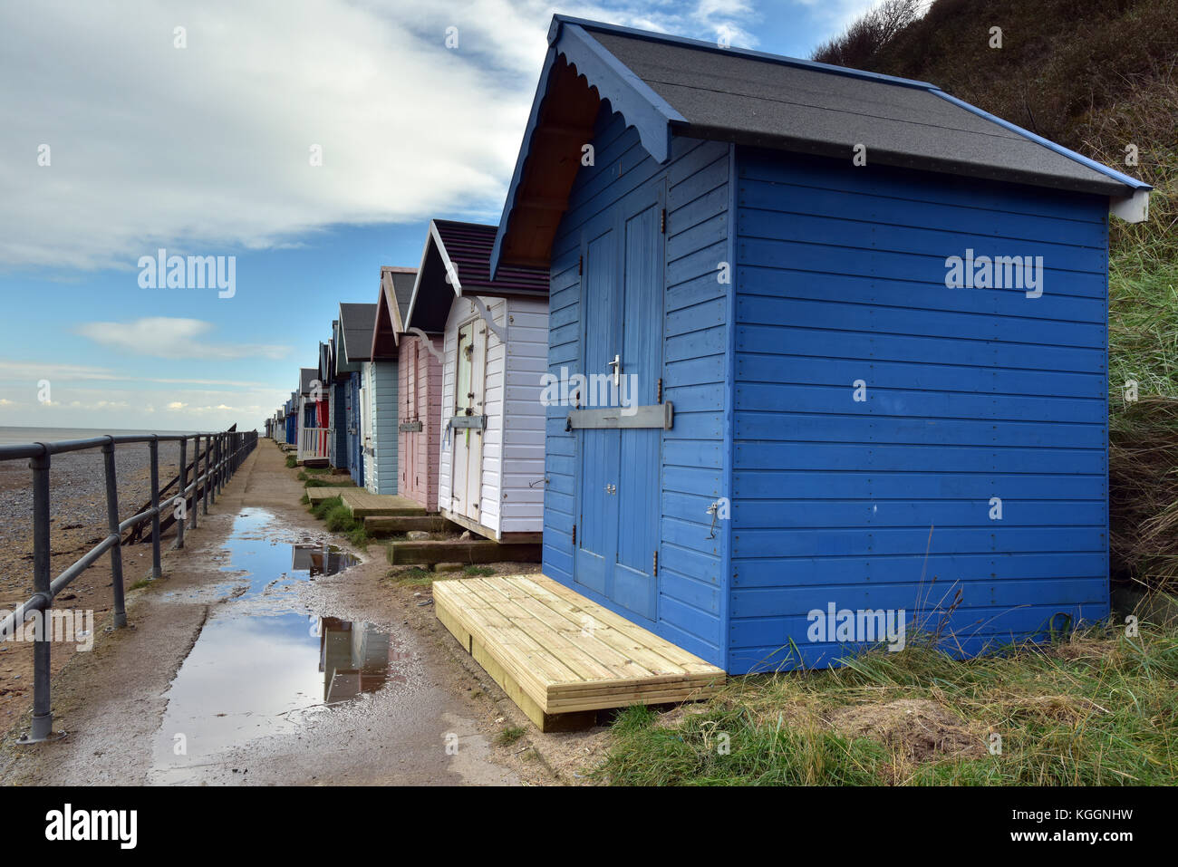 colourful beach huts on the seafront or beaches and sand at Cromer in ...