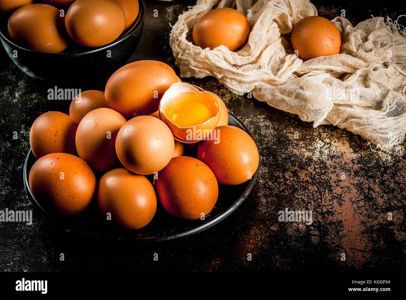 Organic farm chicken eggs, on a plate, on a dark rusty metal background ...