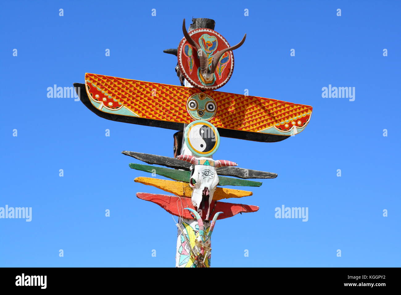A colorful totem column marking someone's grave, symbold and skulls ...