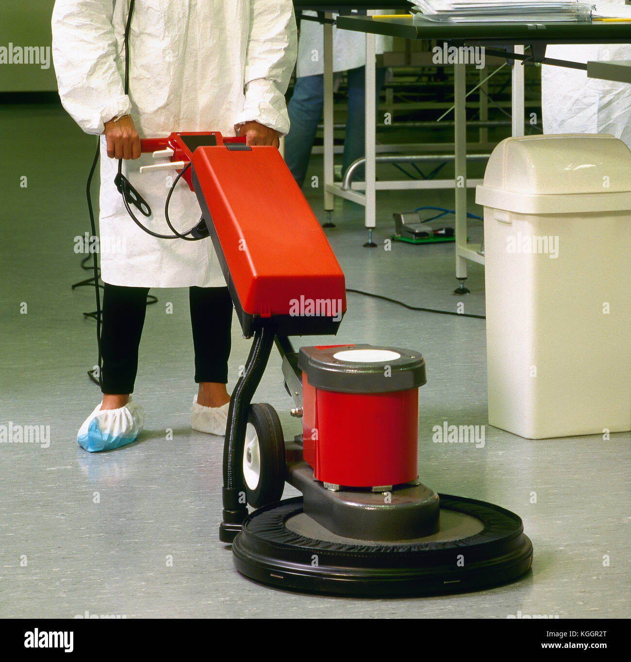 Adult cleaner maid woman with uniform cleaning corridor pass floor ...