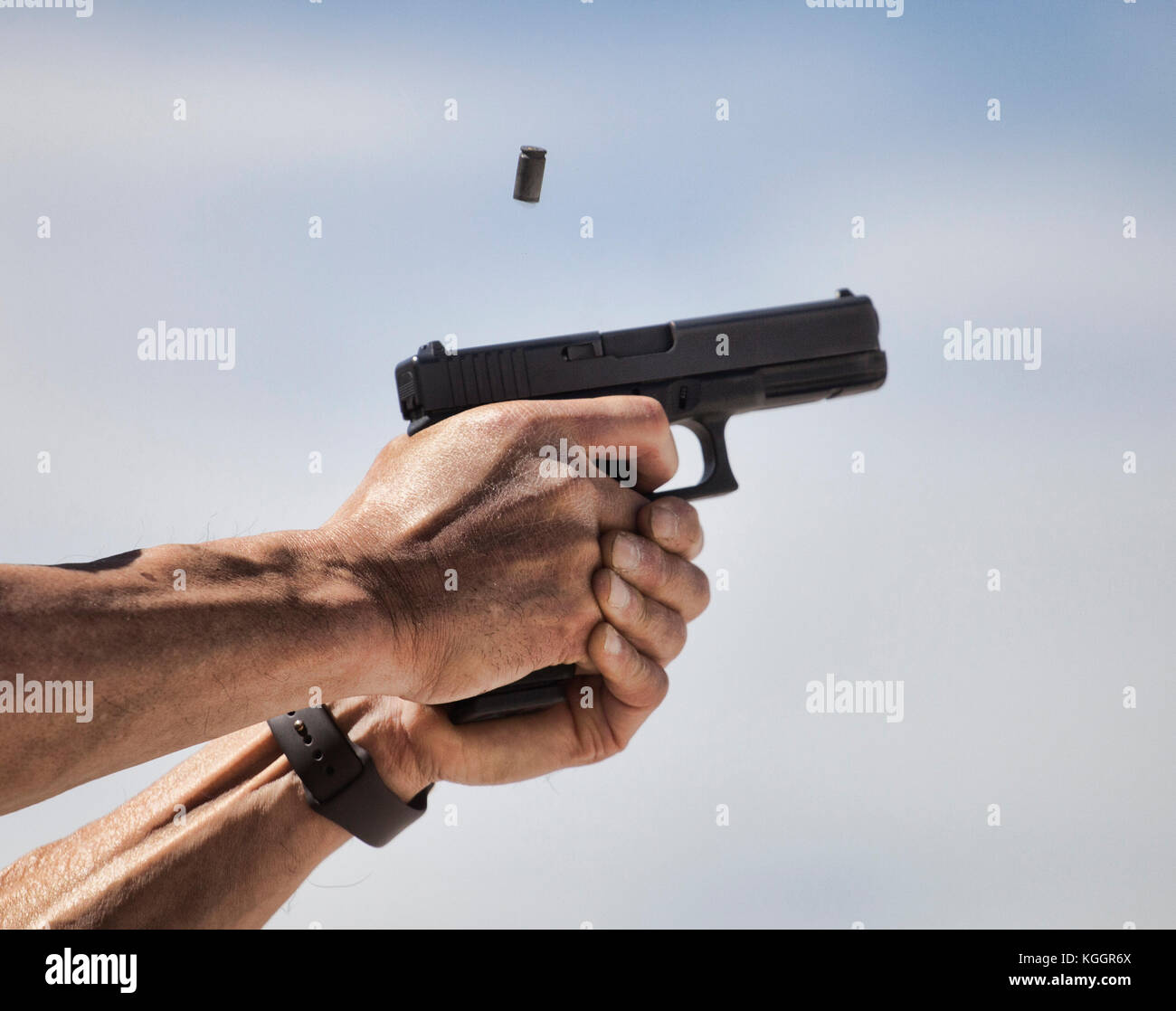 Brass ejected and flying near a pistol while shooting Stock Photo - Alamy