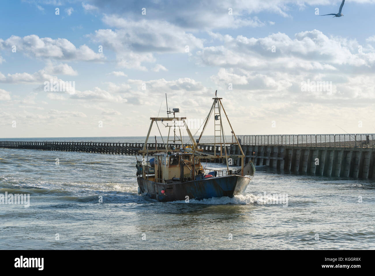 fishing boat entering Littlehampton harbour after a day at sea ...