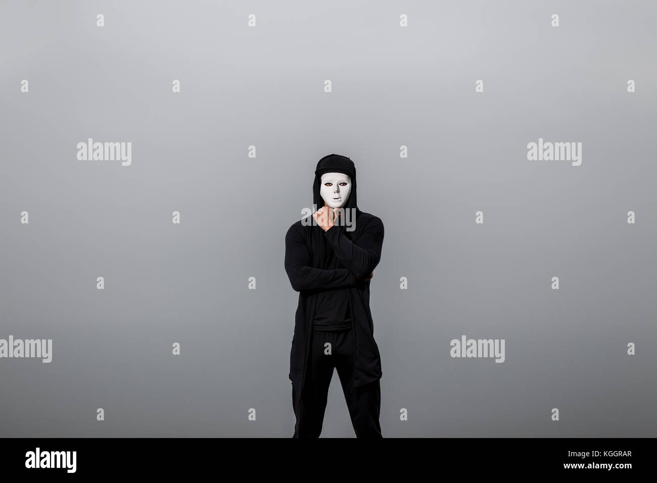 Portrait of man in black hoodie wearing white anonymous mask Stock ... Portrait of man in black hoodie wearing white anonymous mask Stock ...