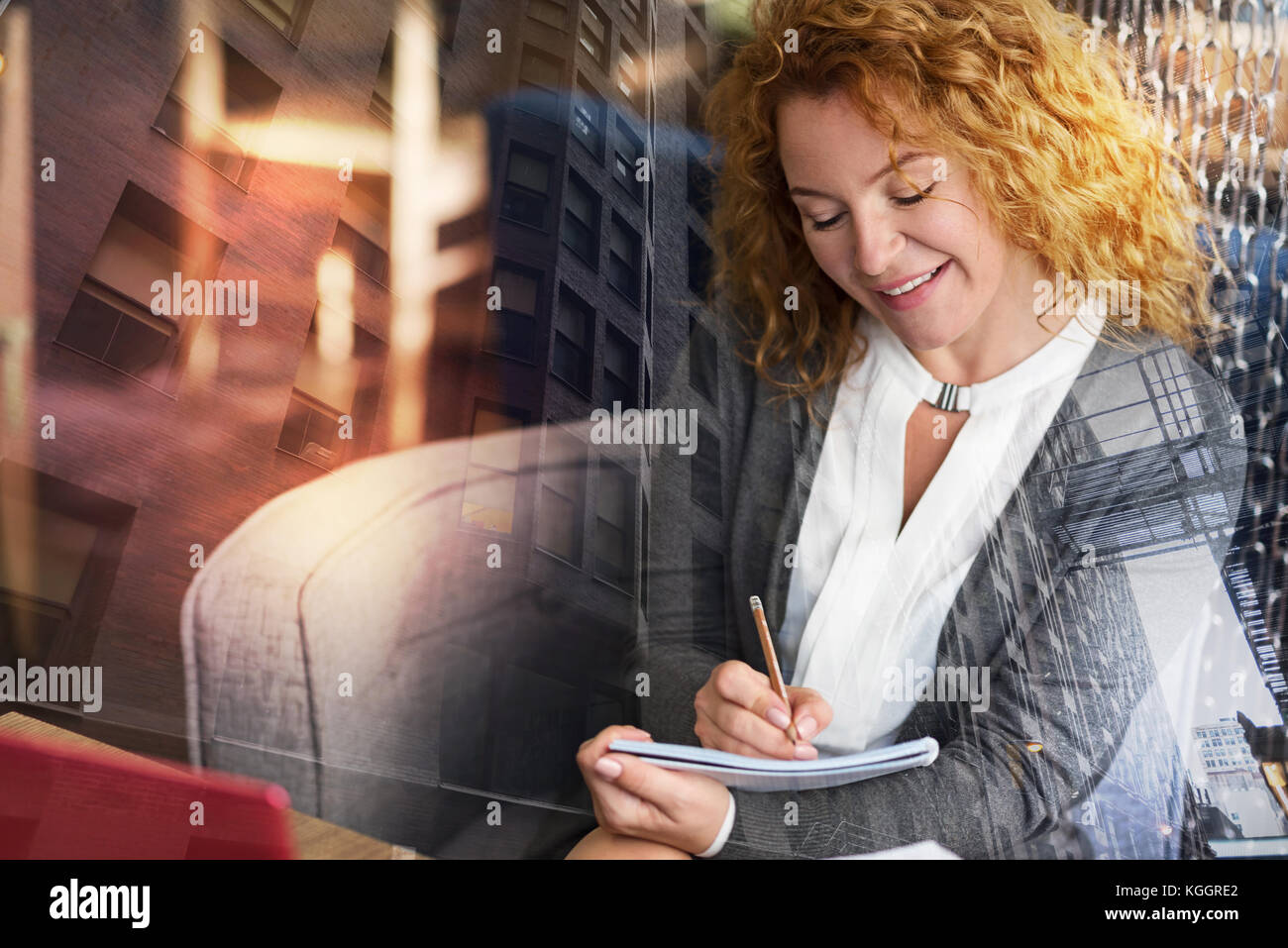 Beautiful woman writing poems in her notebook Stock Photo - Alamy