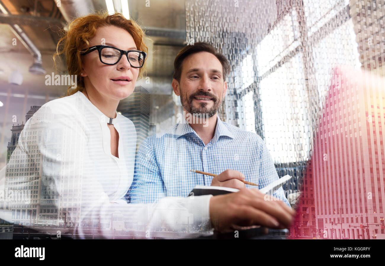 Beautiful woman showing presentation to her colleague Stock Photo - Alamy
