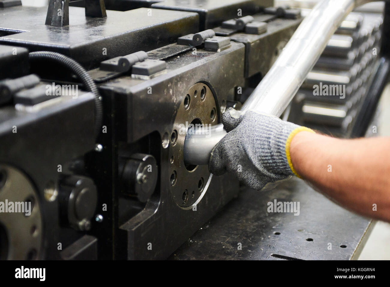 Inside a factory, industrial worker in action on metal machine Stock ...