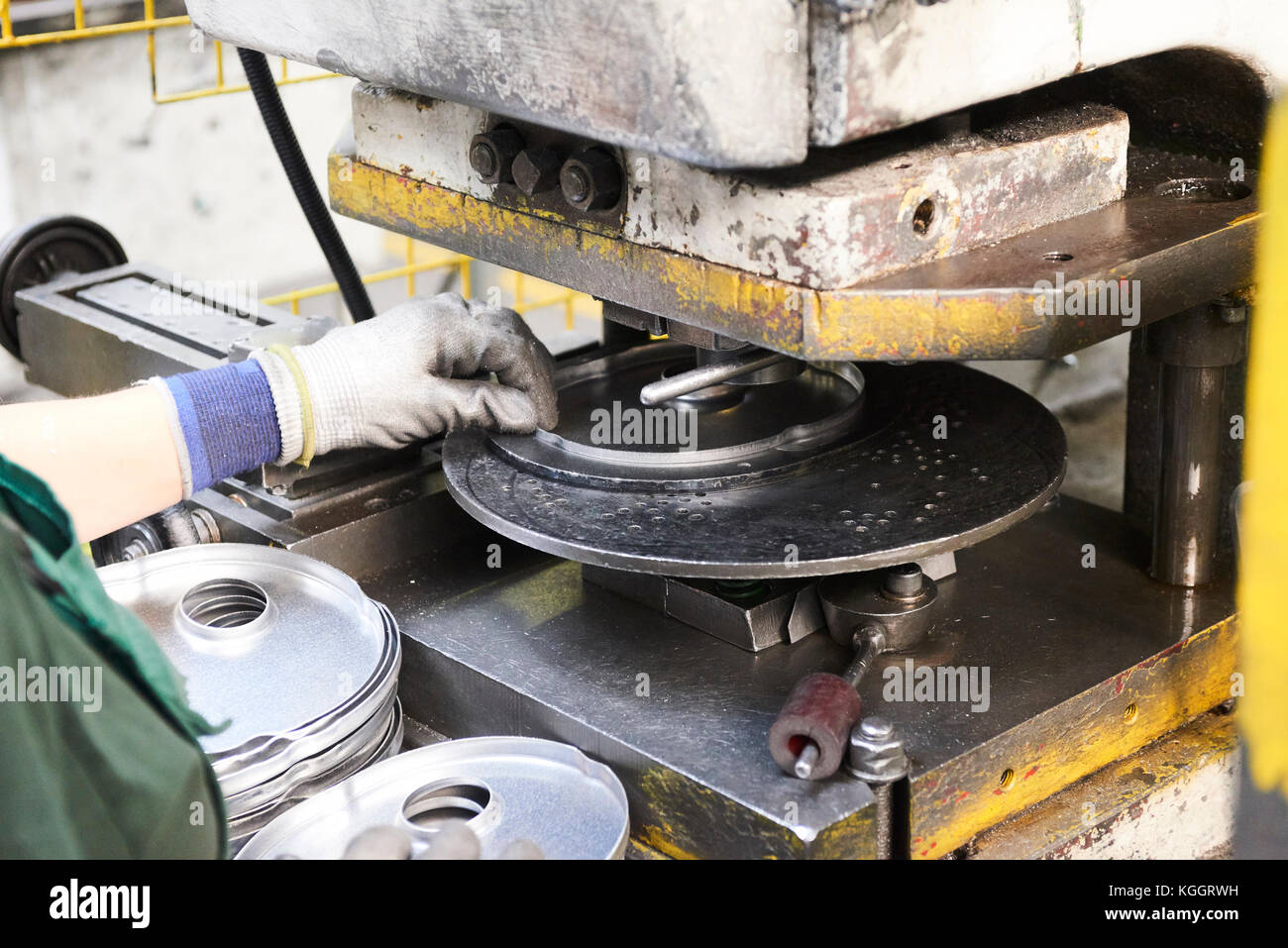 Inside a factory, industrial worker in action on metal machine Stock ...