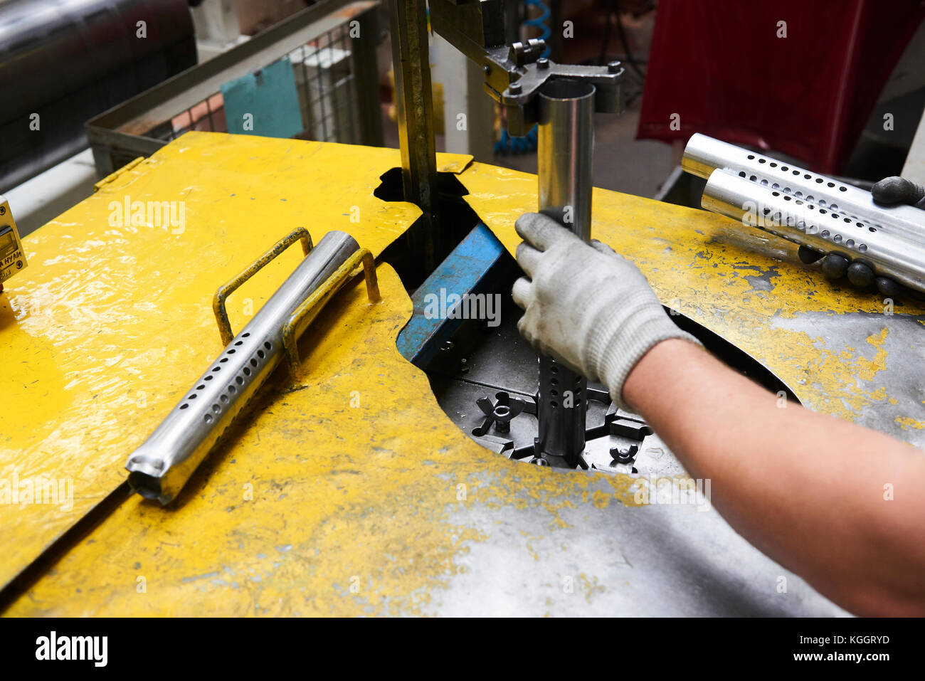 Inside a factory, industrial worker in action on metal machine Stock ...