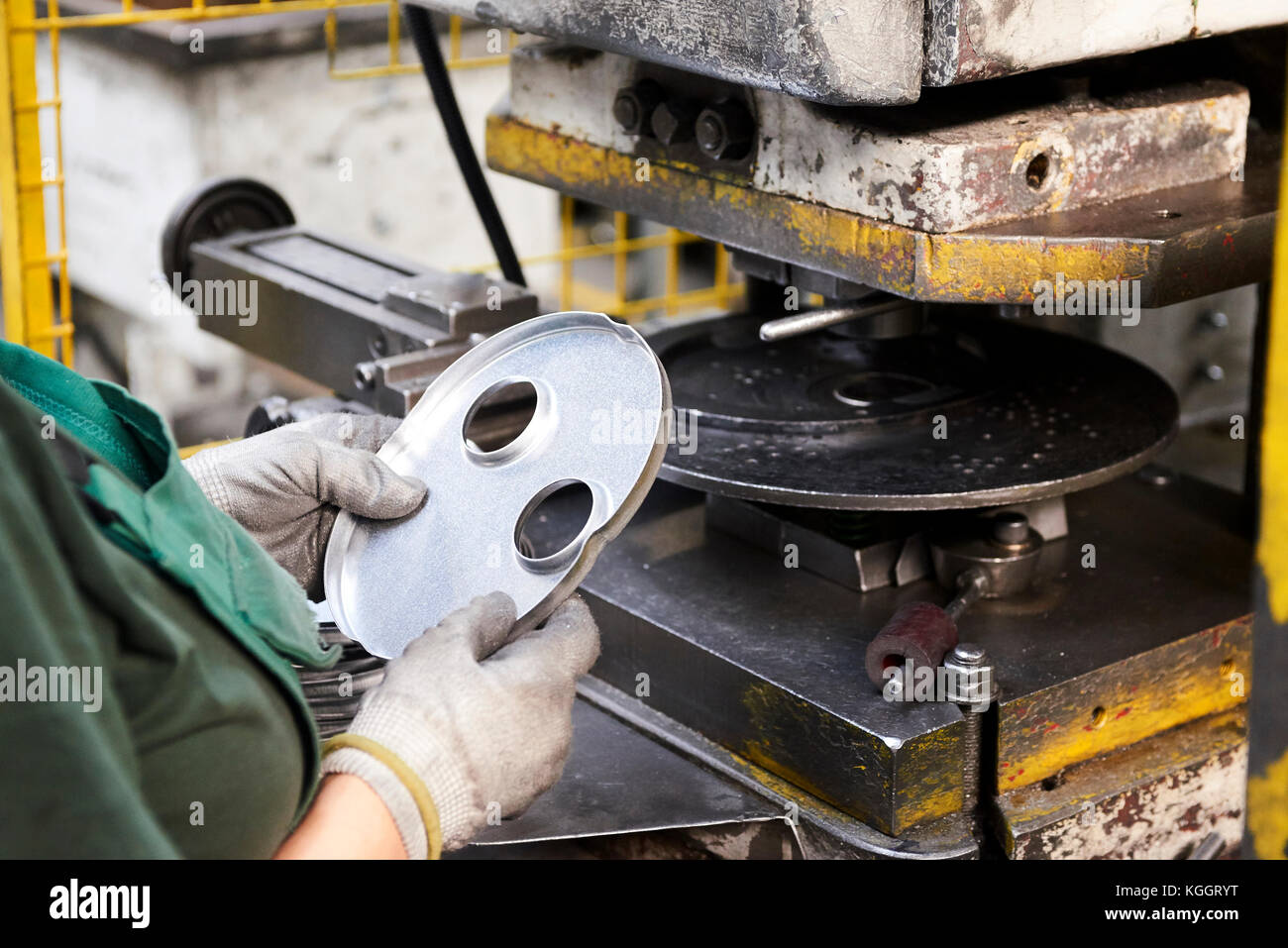 Inside a factory, industrial worker in action on metal machine Stock ...