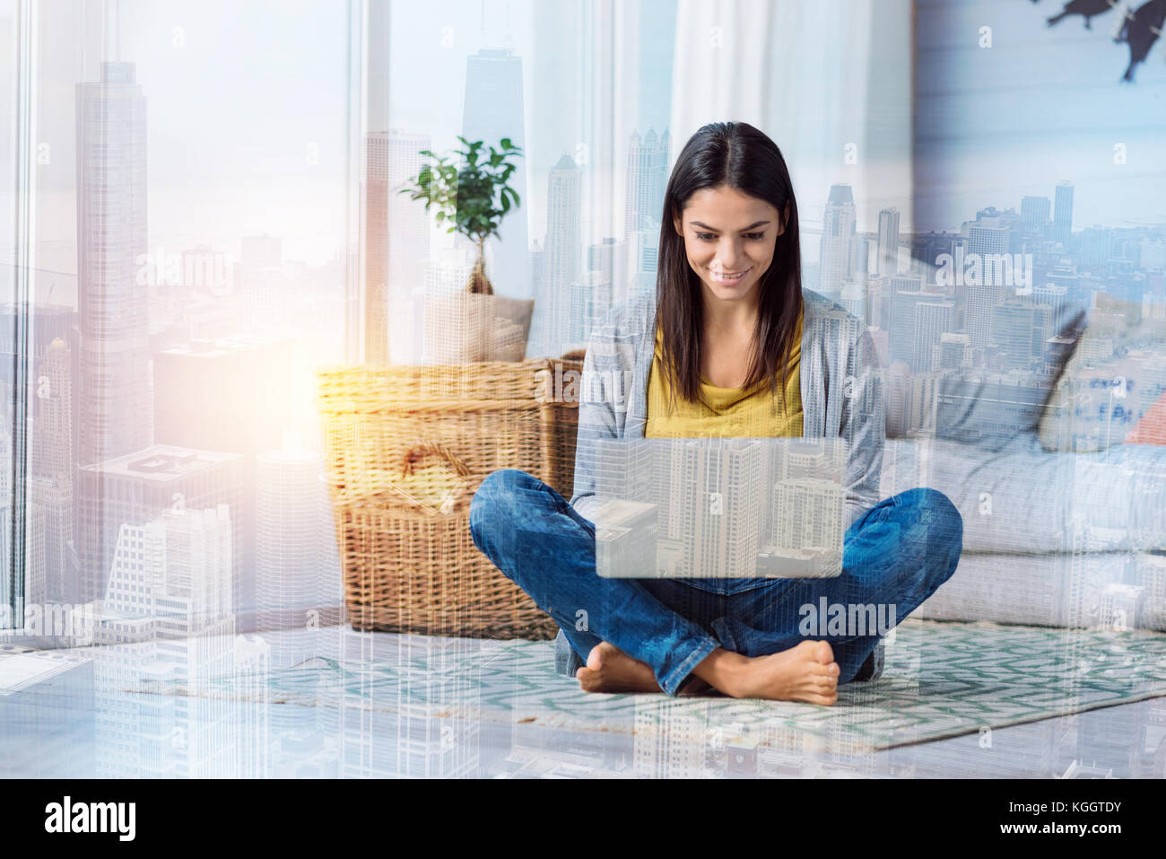 Working mood. Smiling cheerful young woman looking at the screen of her ...