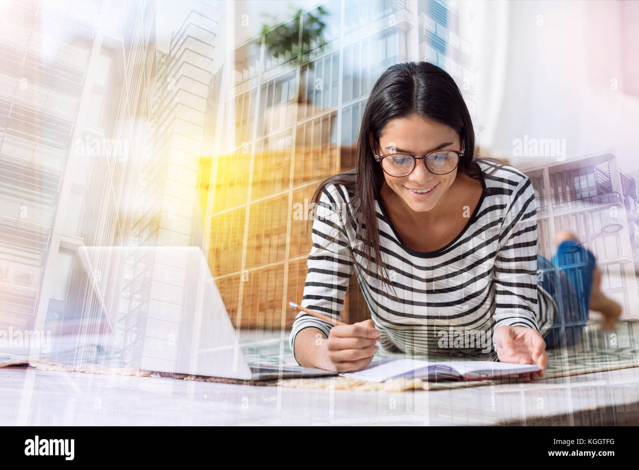 Clever responsible student doing her homework while being in a ...