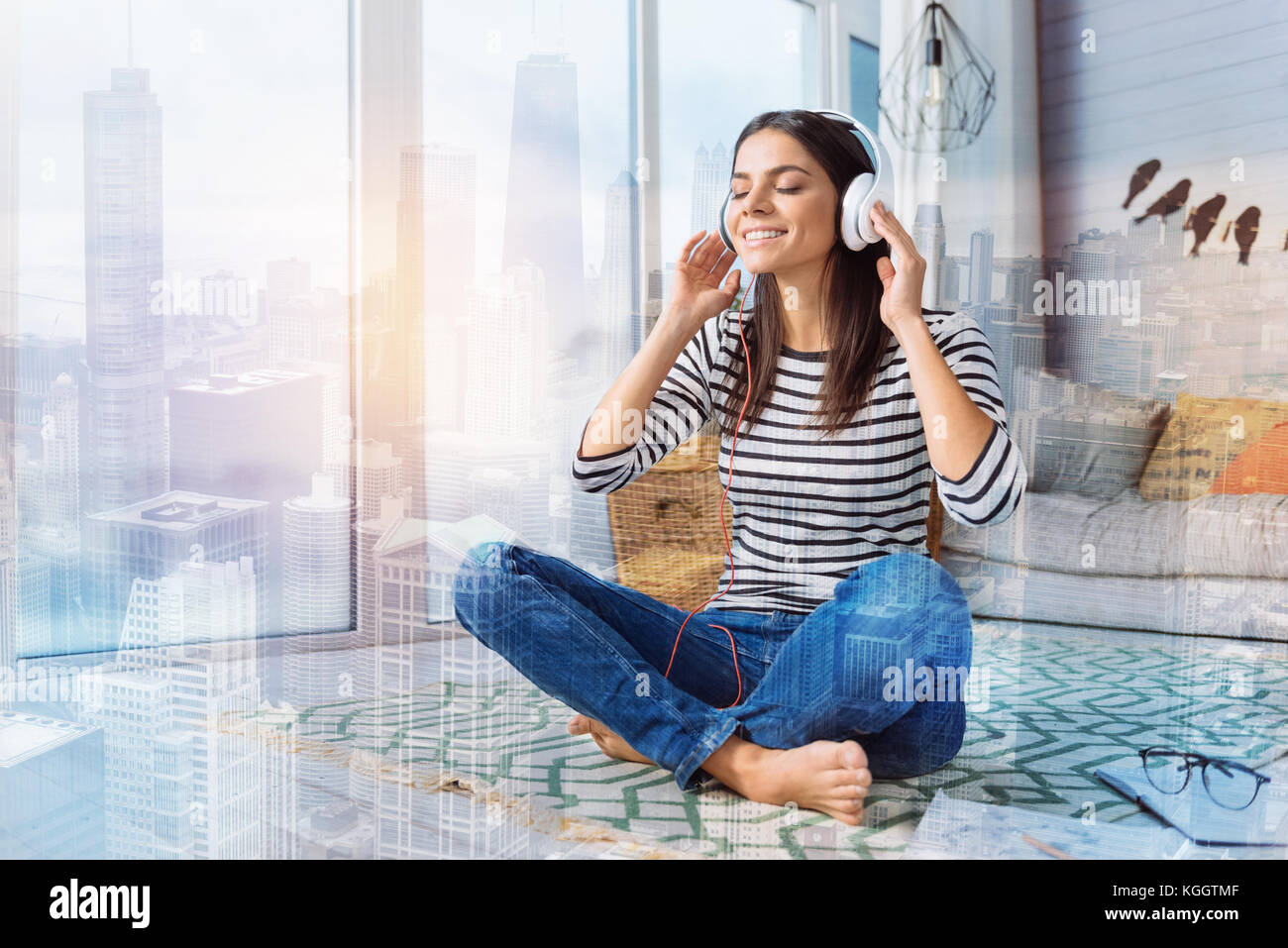 Happy woman relaxing while listening to the music at home Stock Photo ...