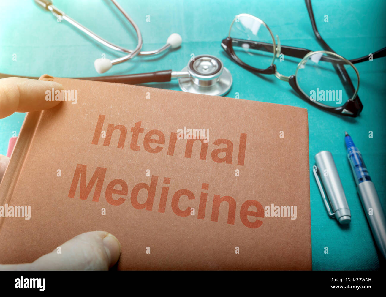 Doctor holds book on internal medicine in a hospital Stock Photo - Alamy